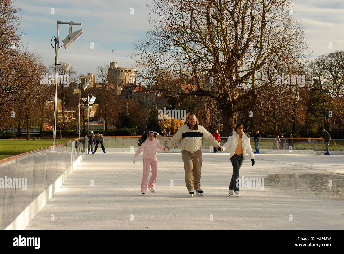 Visitors to Windsor, England, having fun on a temporary skating rink ...