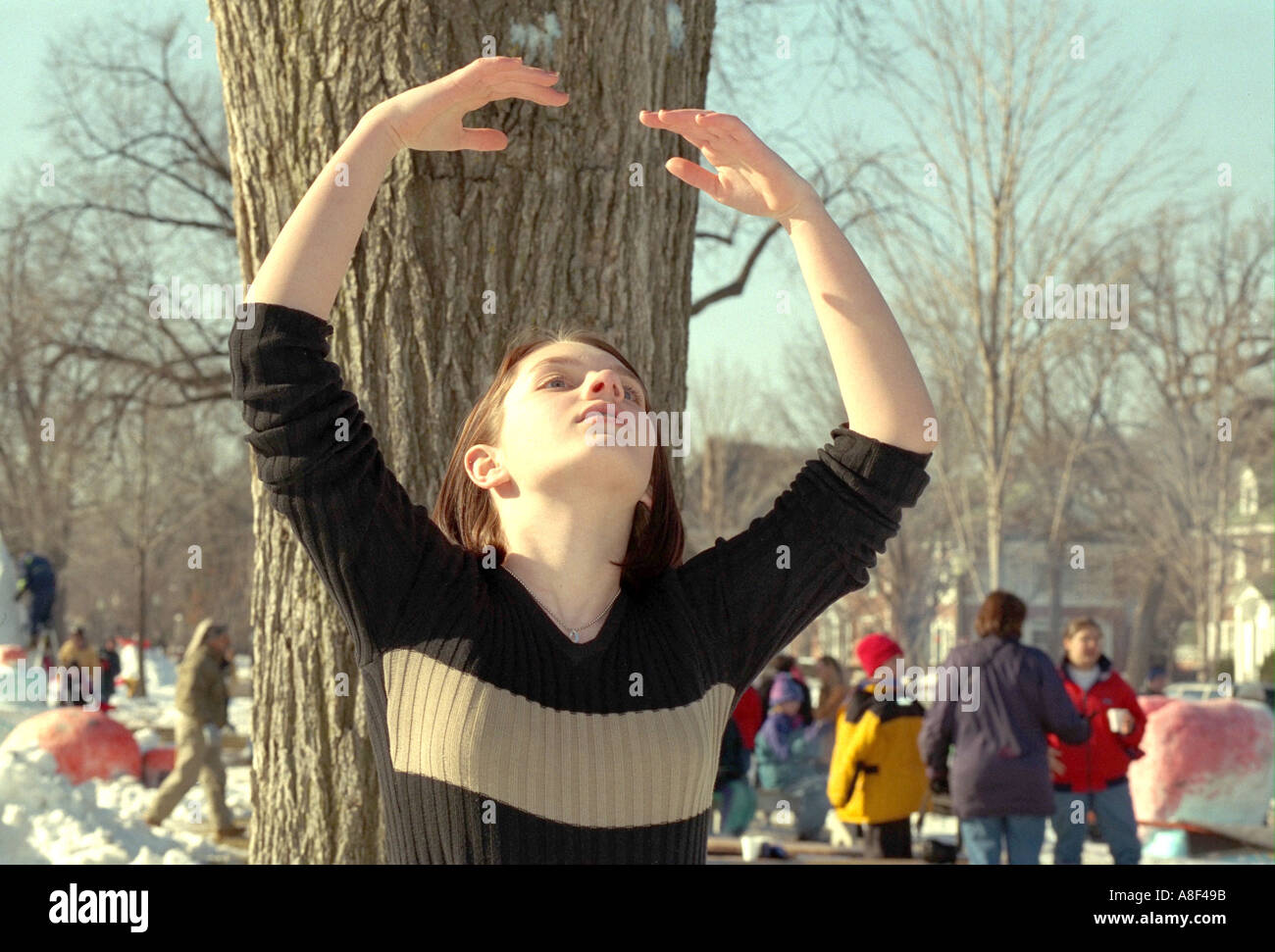 Ballet dancer age 16 with arms in fifth position at the Winter carnival ...