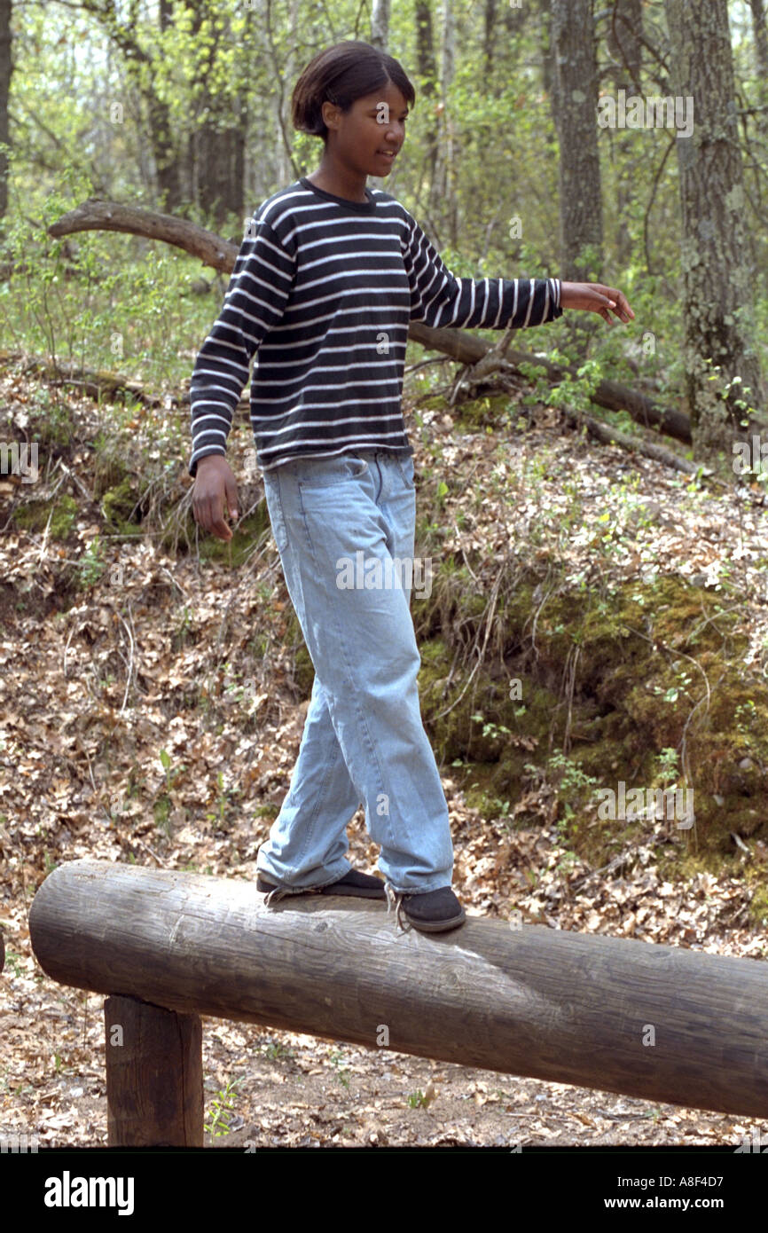 Teen age 15 balancing on wooden beam at confidence course. Camp Ripley ...