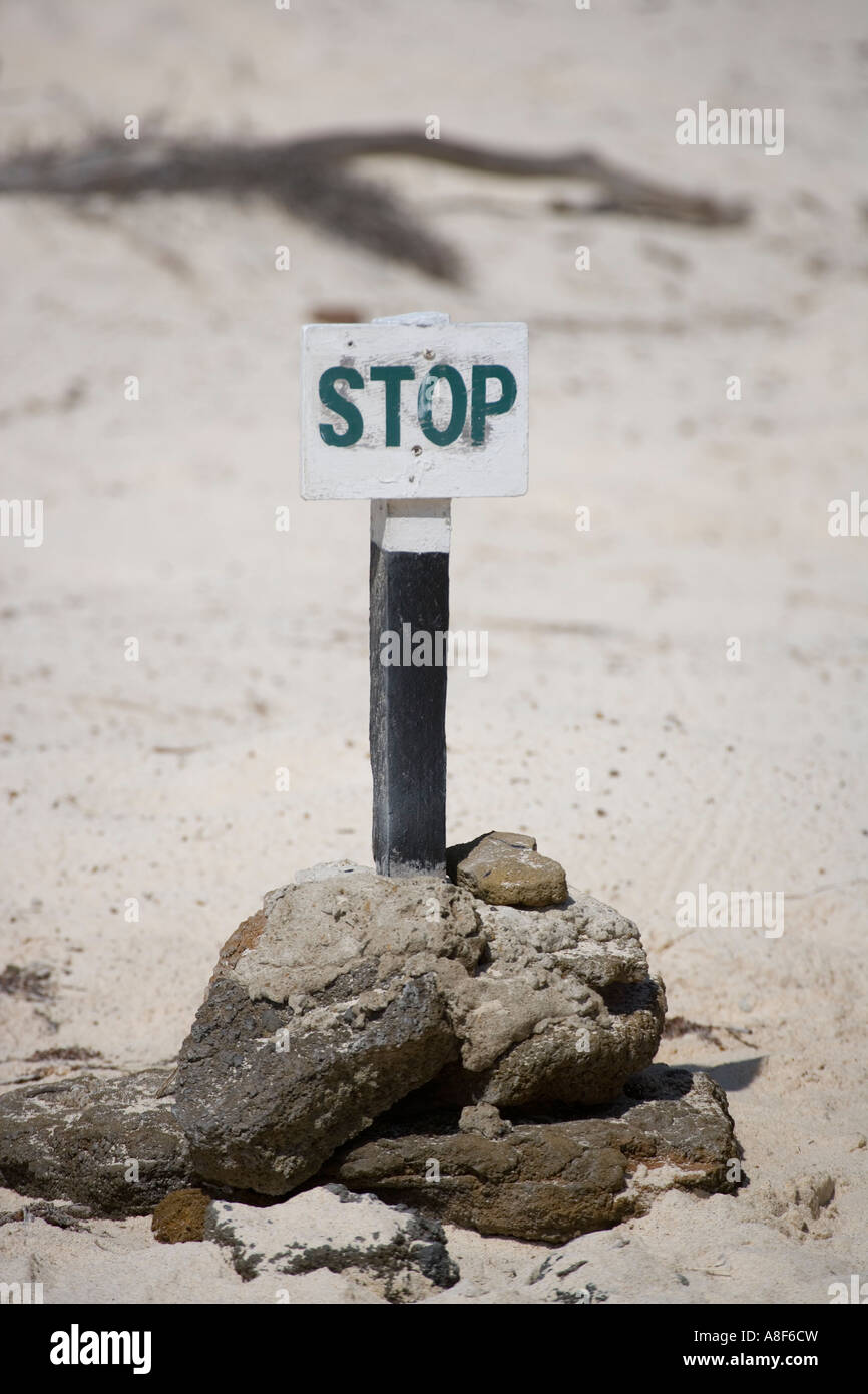 A stop sign on a tourist trail at Punta Cormorant on the Island of ...