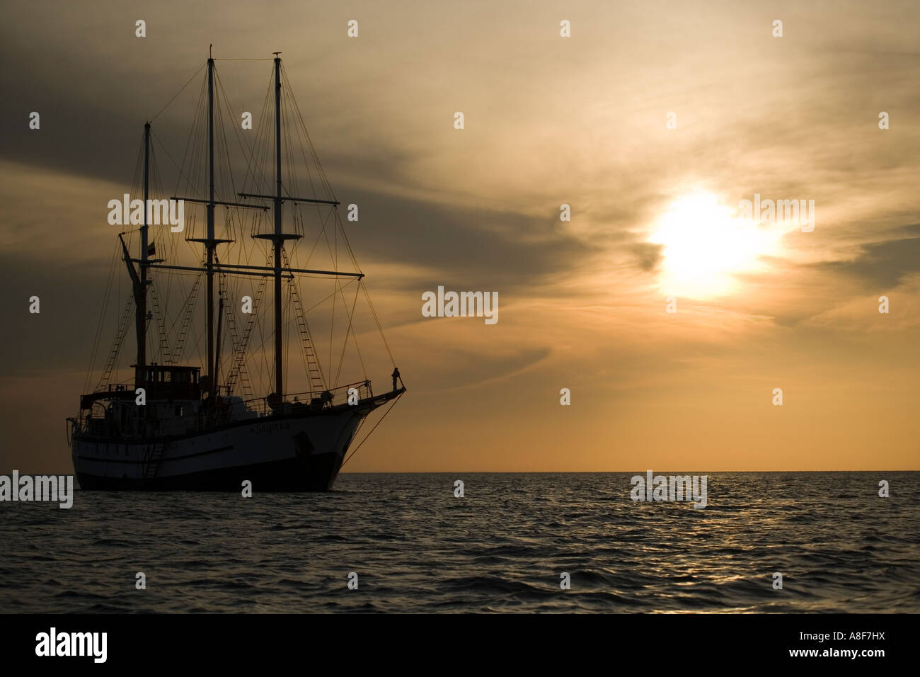 A sailing boat named Sagitta at sunset off the island of Isabela ...
