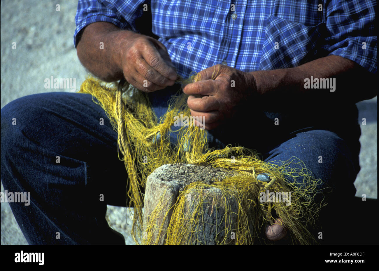 Hands mending fishing nets hi-res stock photography and images - Alamy
