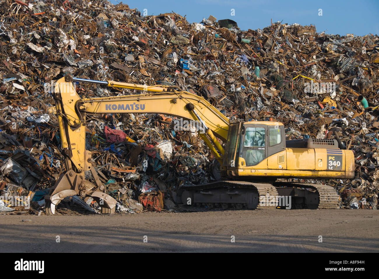 A pile of scrap metal ready for recycling, with dormant machinery in ...