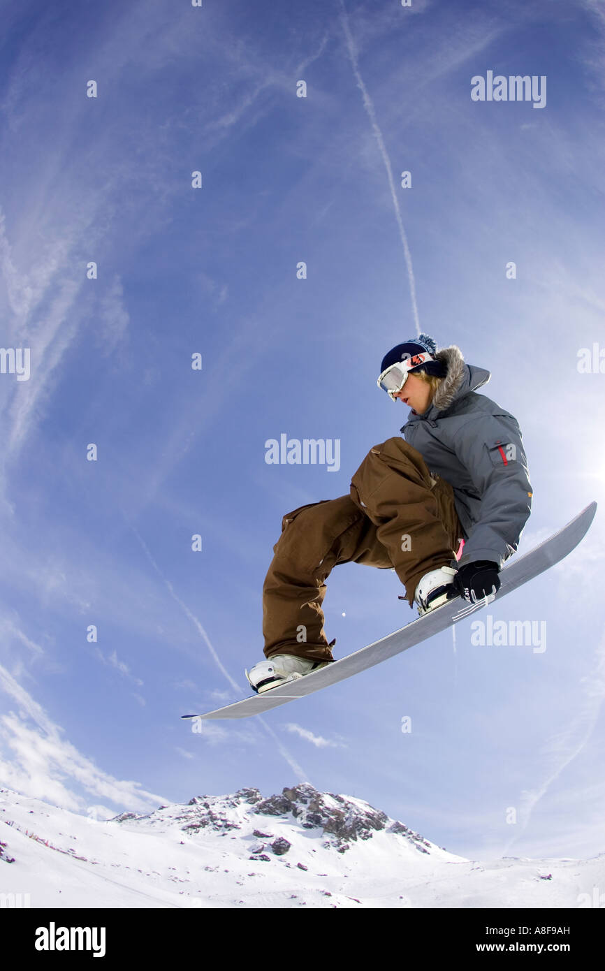Snowboarder mid air grabs board Stock Photo - Alamy