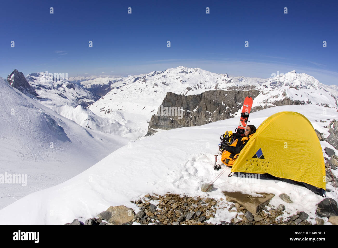 Female mountaineer camped on snowy mountain Stock Photo - Alamy
