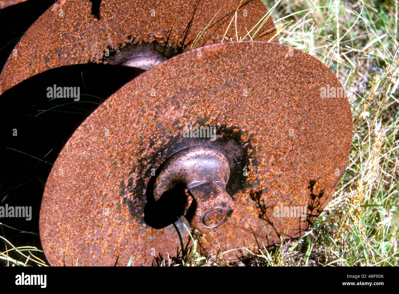 rusty farm equipment on grass Stock Photo - Alamy
