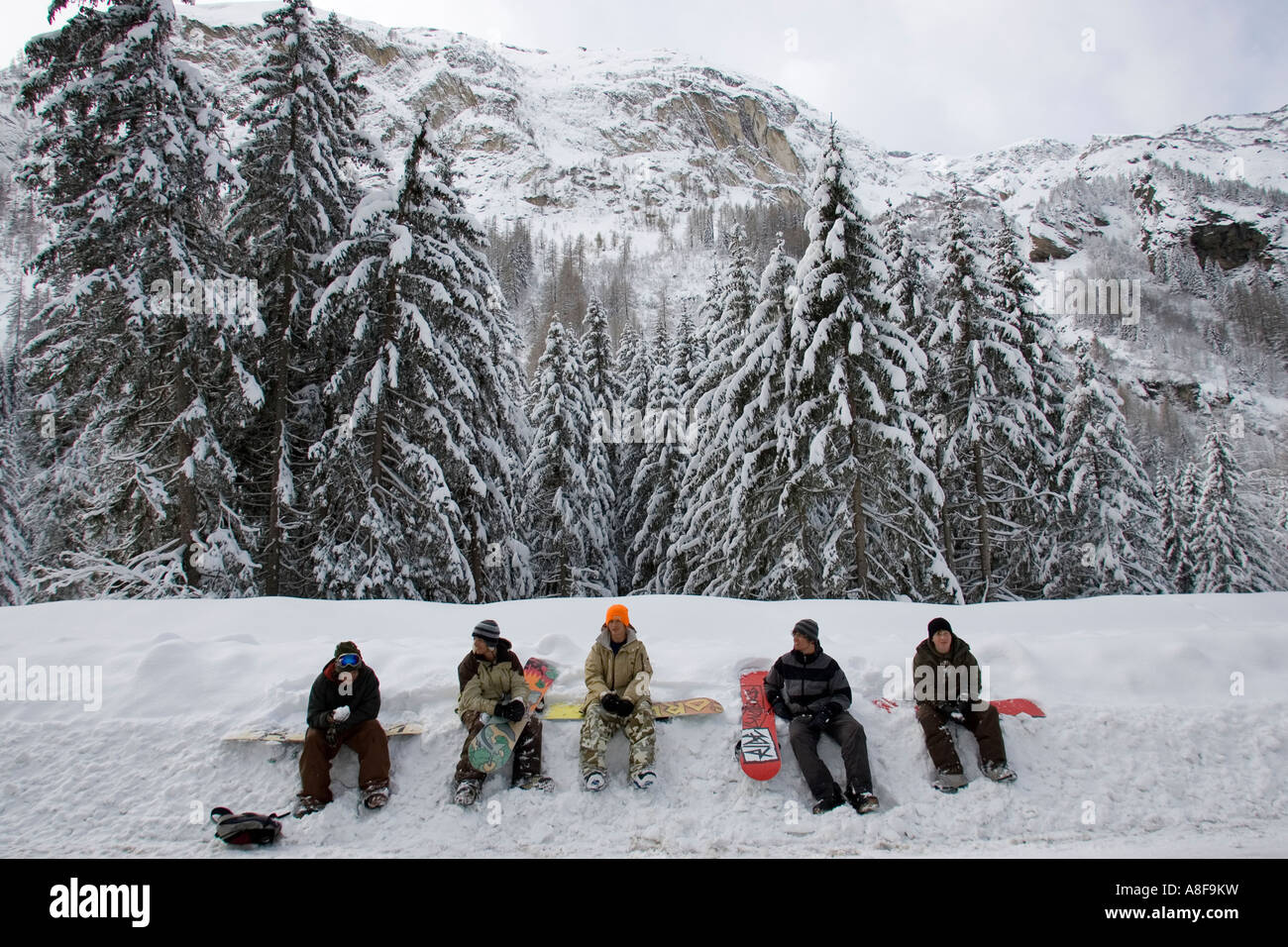 Snowboarding friends laughing and chatting at the end of a days ...
