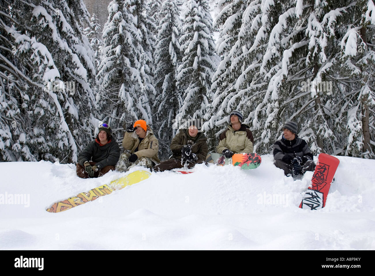 Group of snowboarders relaxing and talking after a days snowboarding ...