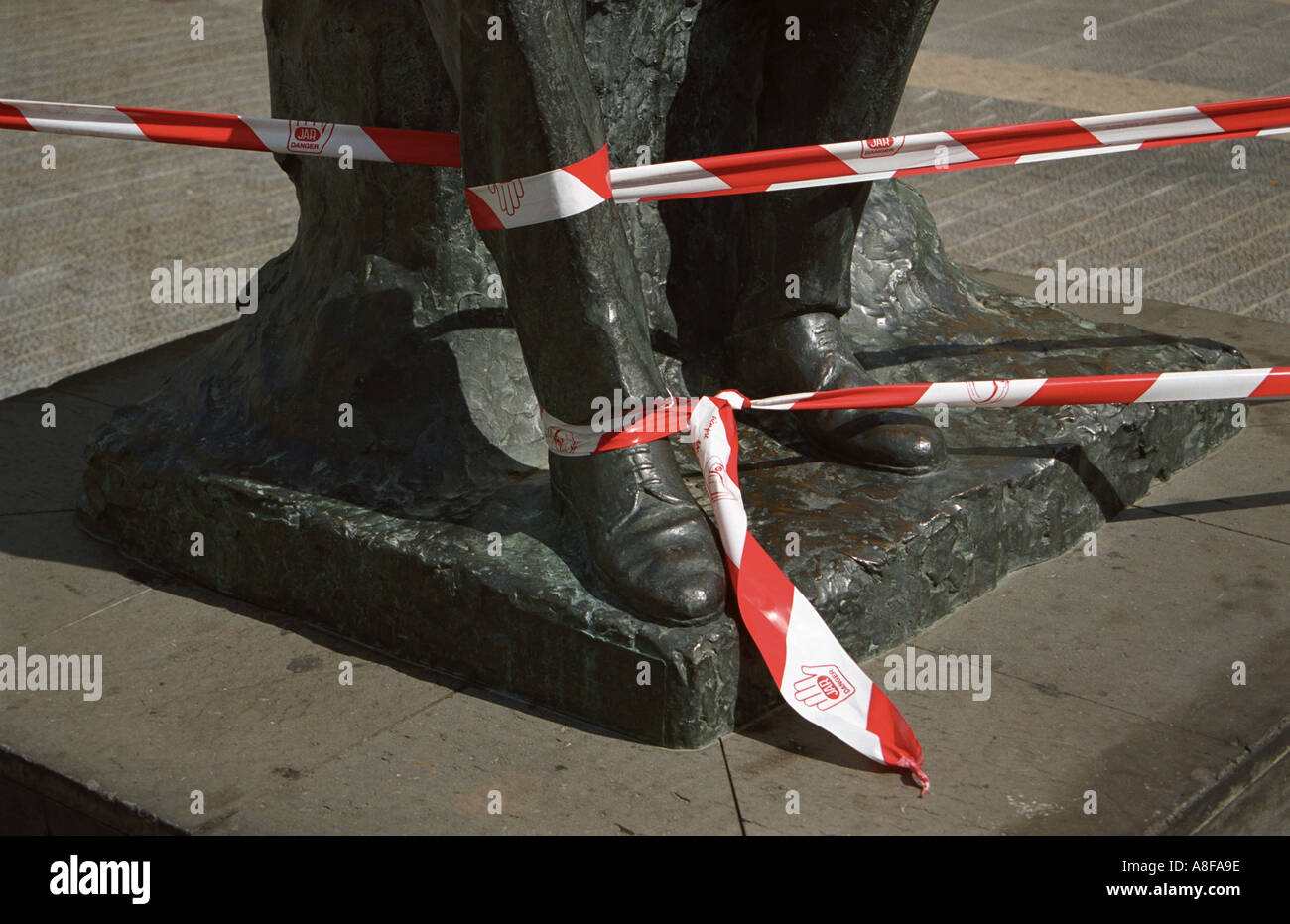 Do not cross tape tied up at the statue foot Stock Photo - Alamy