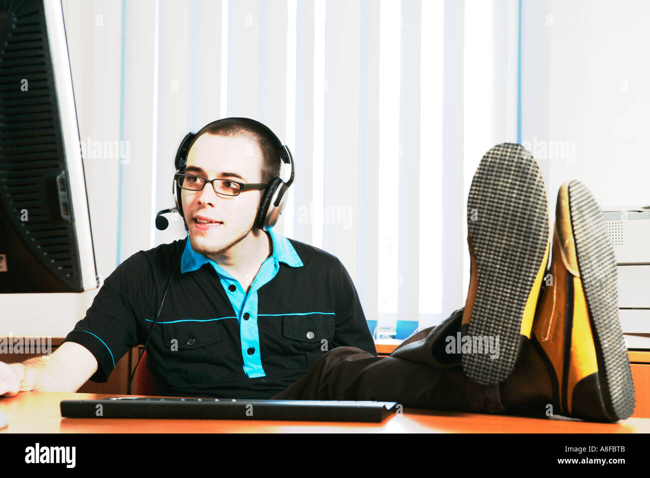MAN IN OFFICE WITH HIS FEET ON THE DESK Stock Photo - Alamy