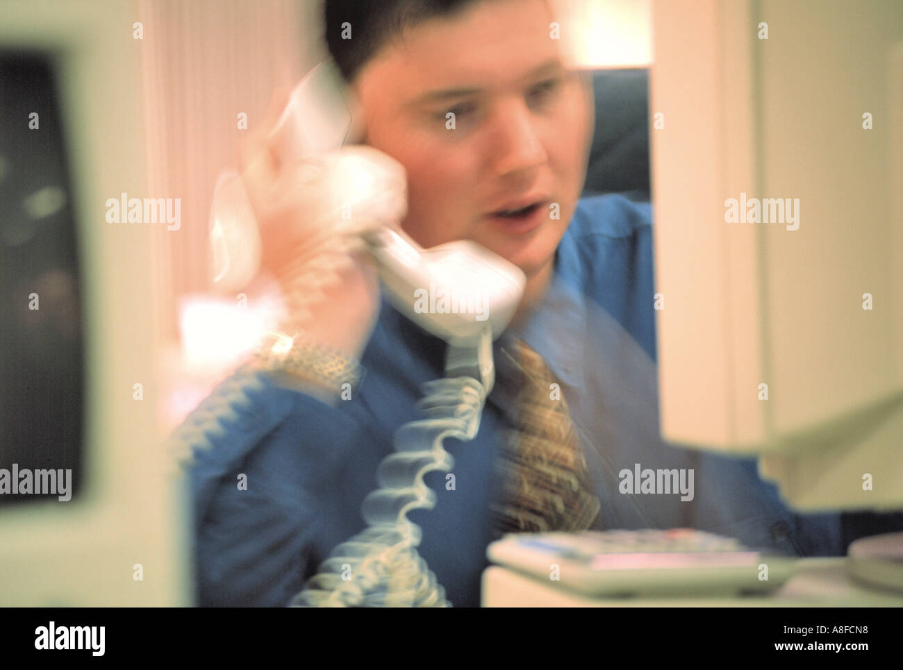 broker with two phones Stock Photo - Alamy