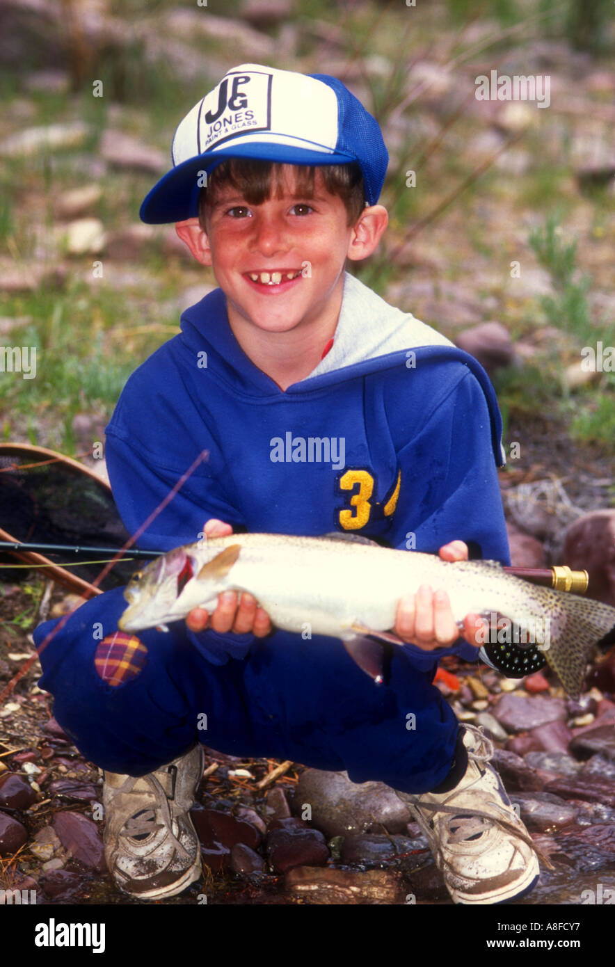 Young smiling white boy holding good size Rainbow trout. Green River ...