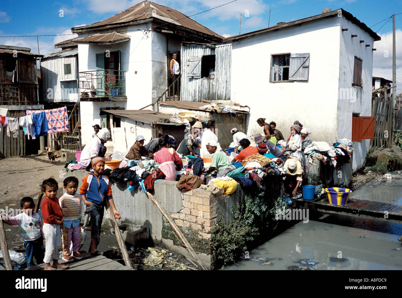 women washing clothes in a poor section of antananarivo madagascar ...