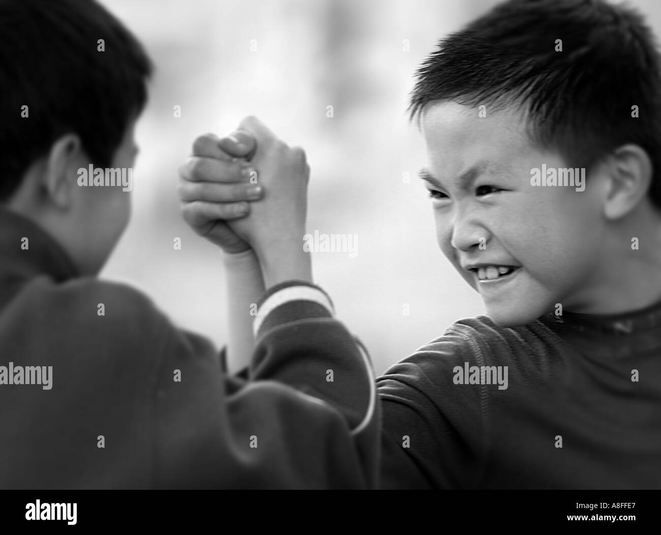 Two children arm wrestling Stock Photo - Alamy