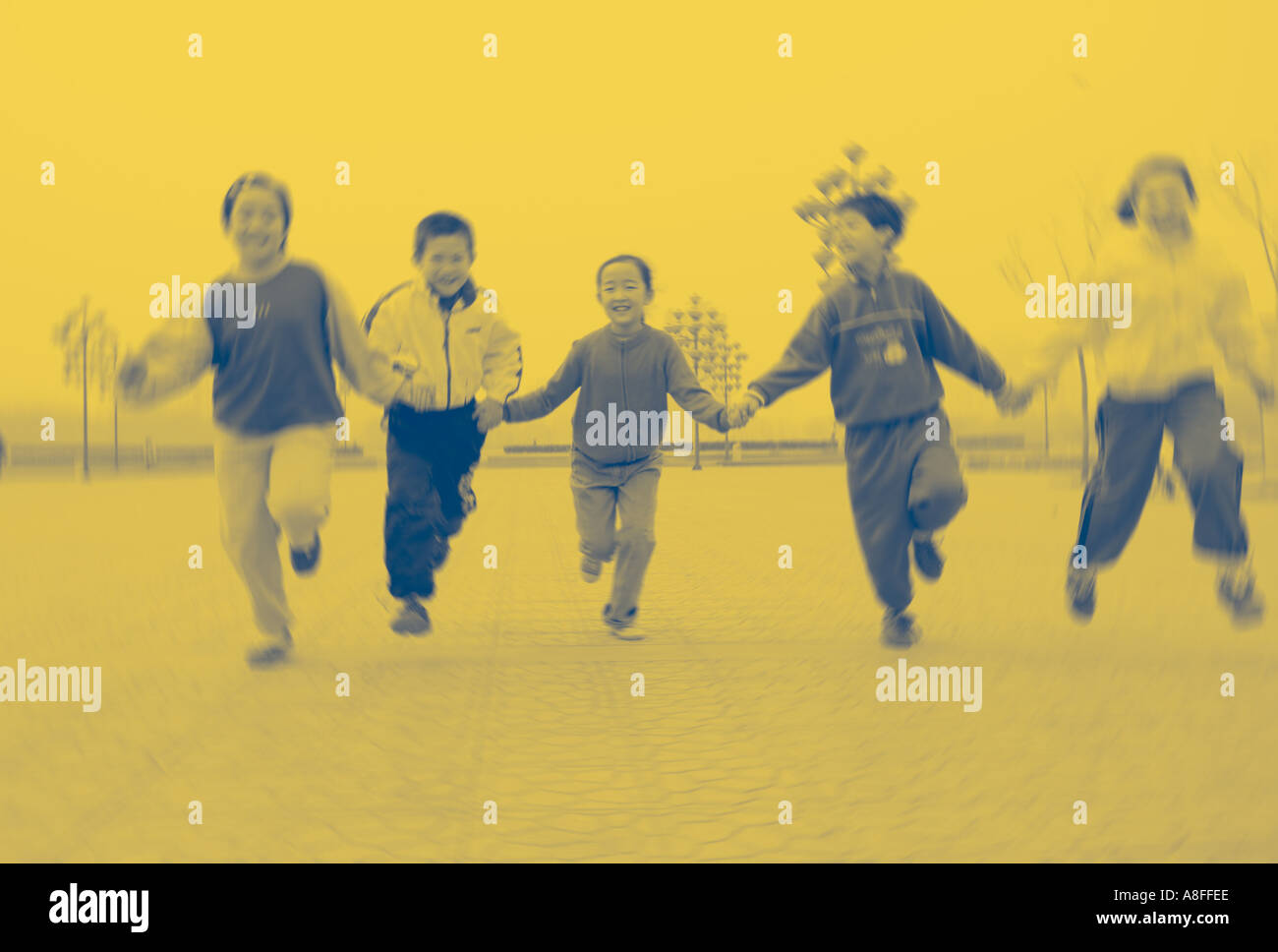 Children running hand in hand in school yard Stock Photo - Alamy