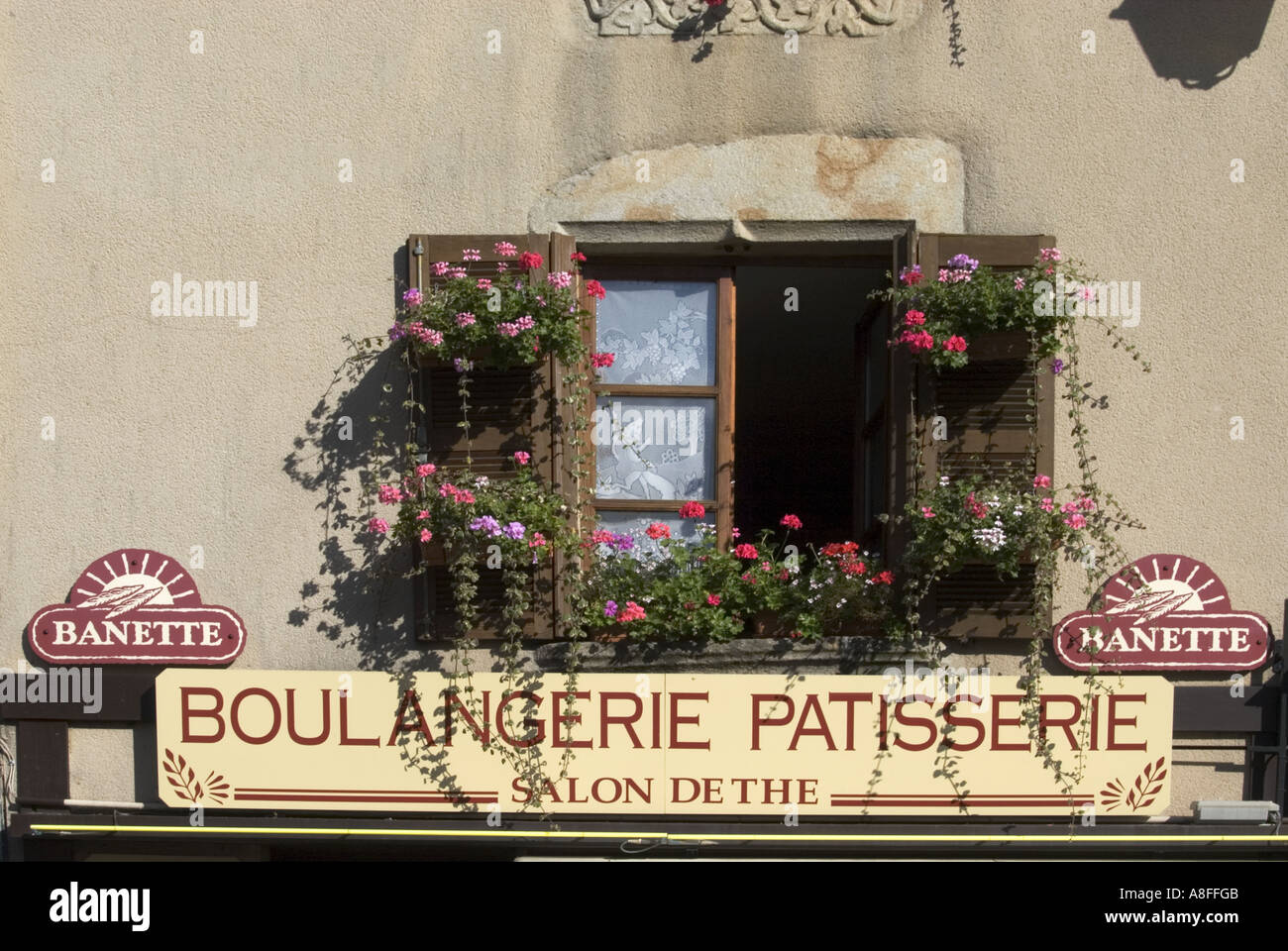 window flower display around a French Boulangerie Stock Photo - Alamy