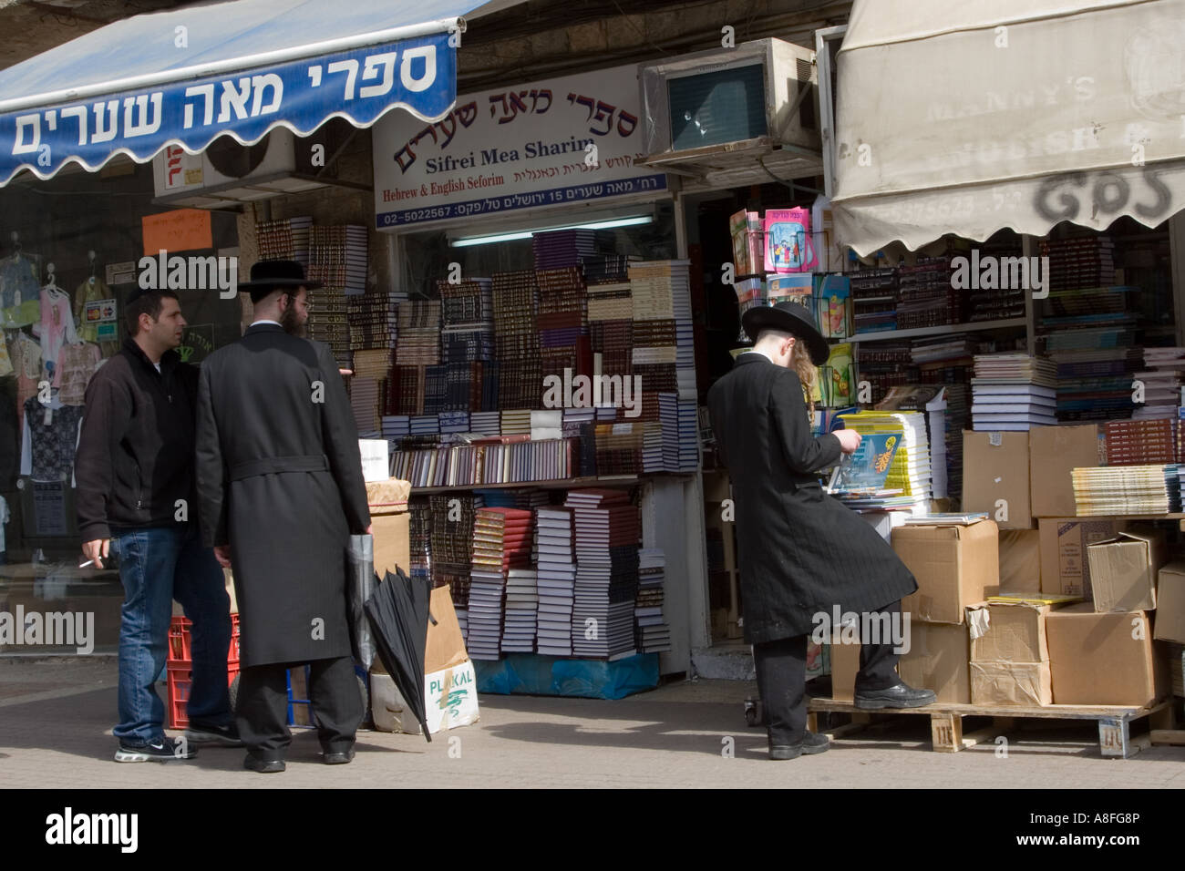 Stock Photo Of Three Men Viewing Books on Display in Front of a ...
