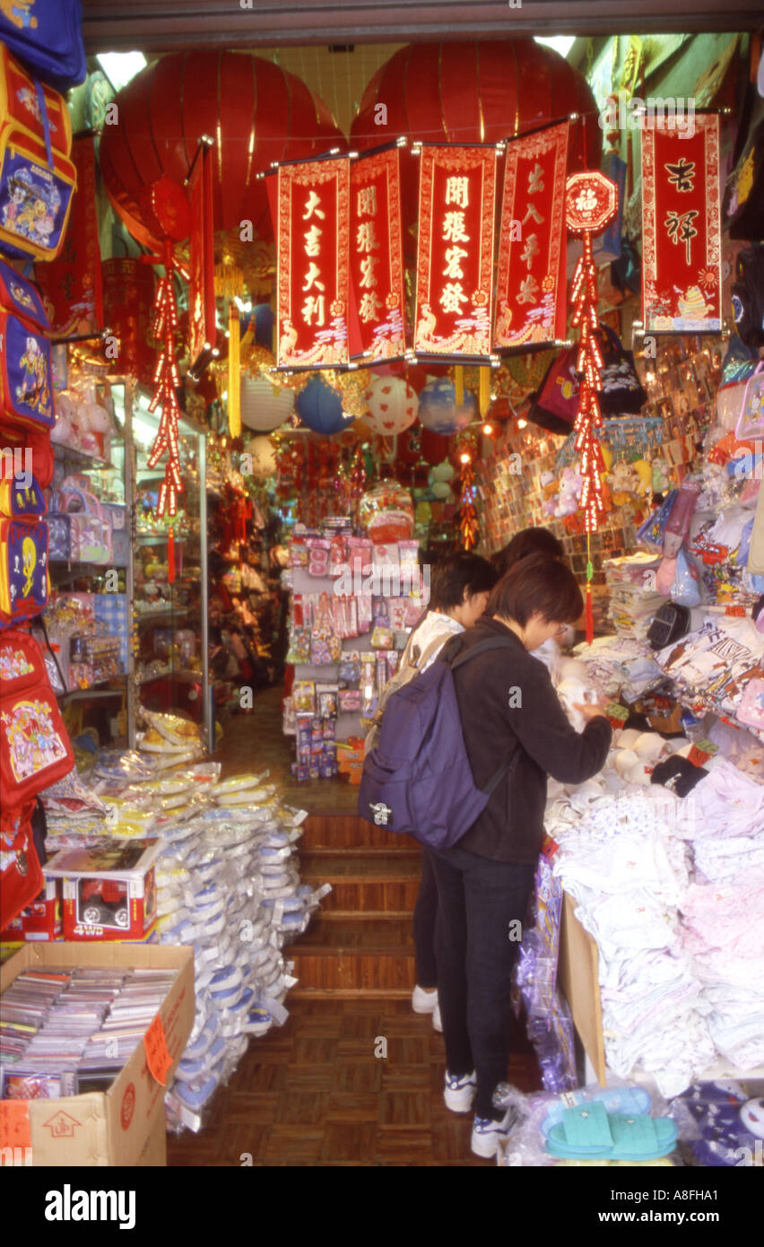 Asian girl shopping for souveniers in a well stocked shop in the Sydney ...