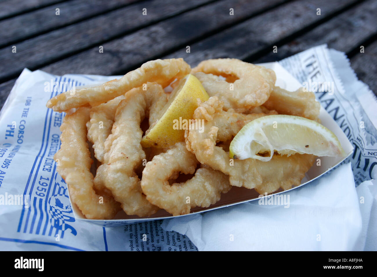 A take away box of calamari with a slice of lemon Stock Photo - Alamy