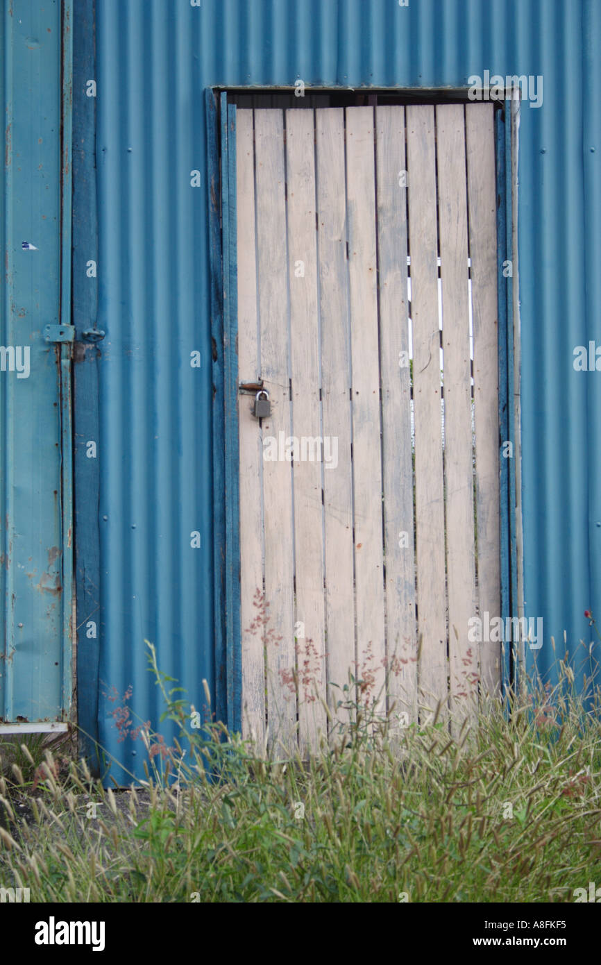 OLD BLUE BUILDING WITH A WHITE DOOR BAPD1202 Stock Photo - Alamy