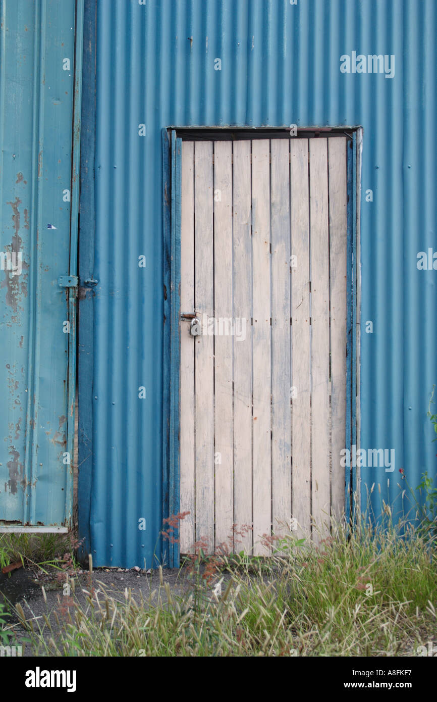 OLD BLUE BUILDING WITH A WHITE DOOR BAPD1203 Stock Photo - Alamy