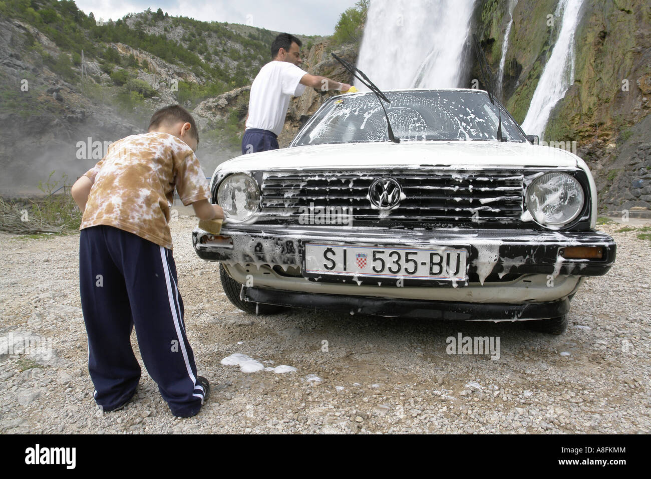 Car washing at Topolskij Buk waterfall source of Krka river near Knin ...