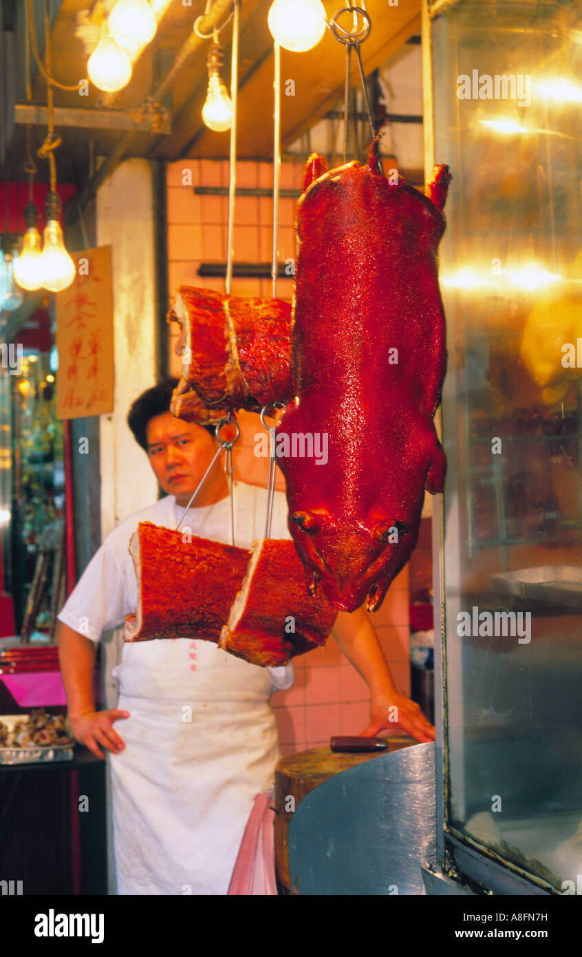 Roasted pork BBQ pig hanging in front of shop hong kong china Stock ...