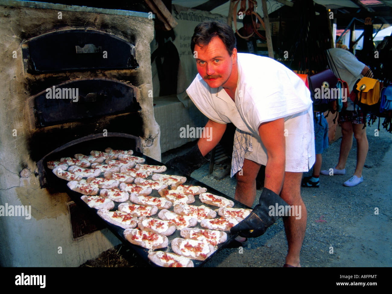 Baker baking bread in ancient style Medieval festival in Kaltenberg ...