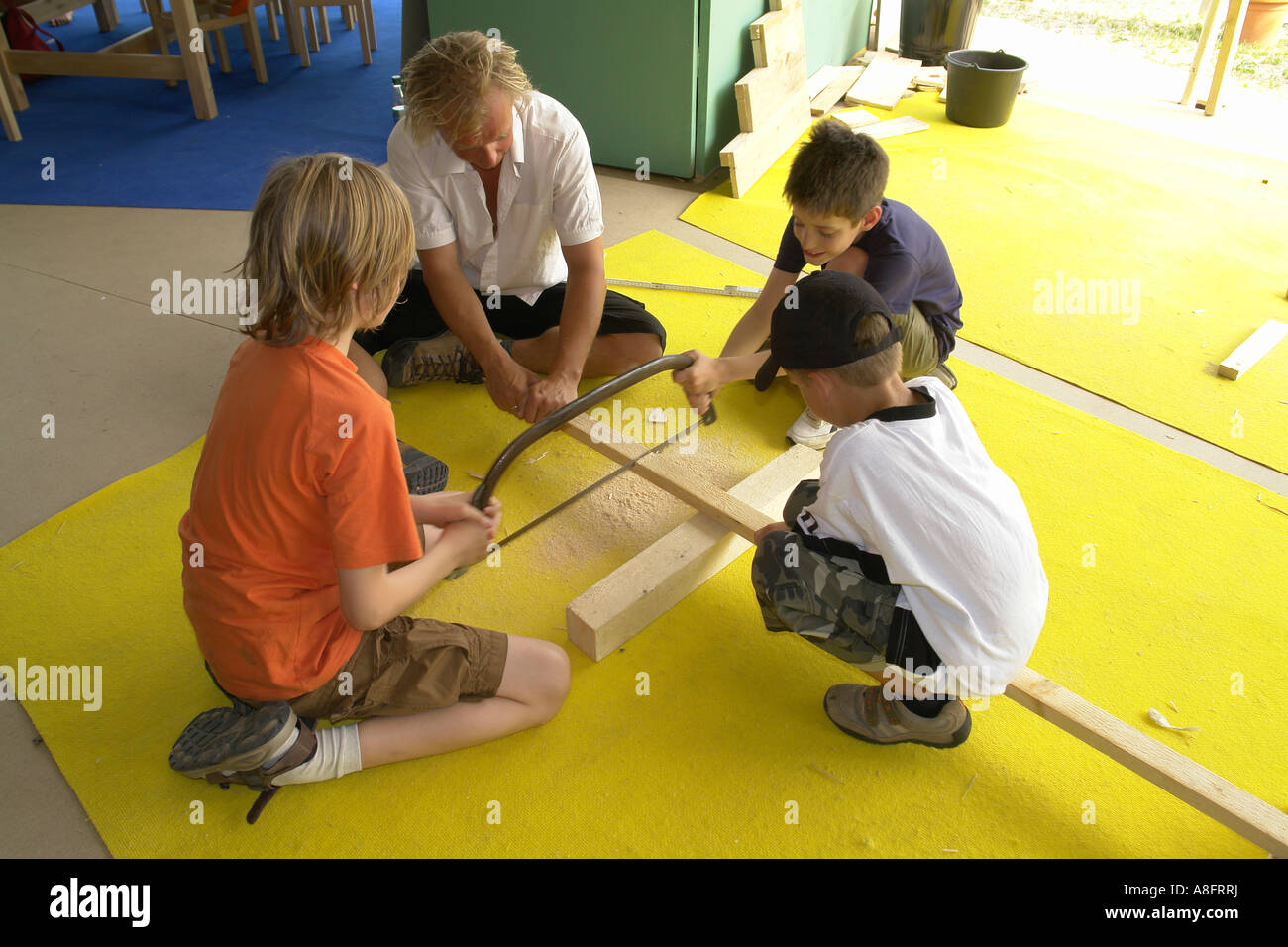 Children sewing wood for handwork Stock Photo - Alamy