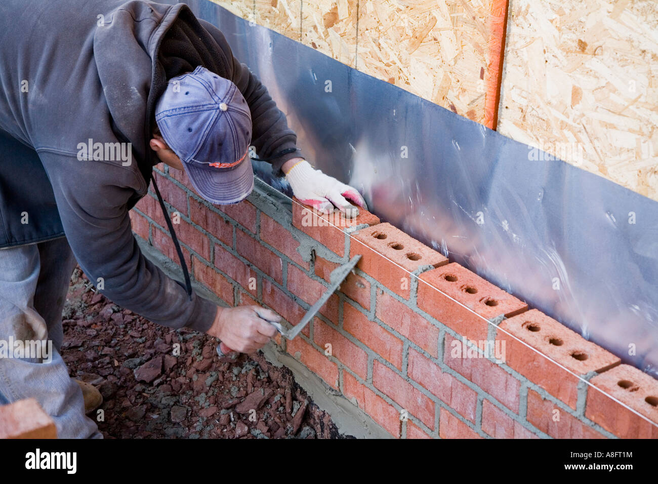 Immigrant Worker Laying Brick Wall Stock Photo - Alamy