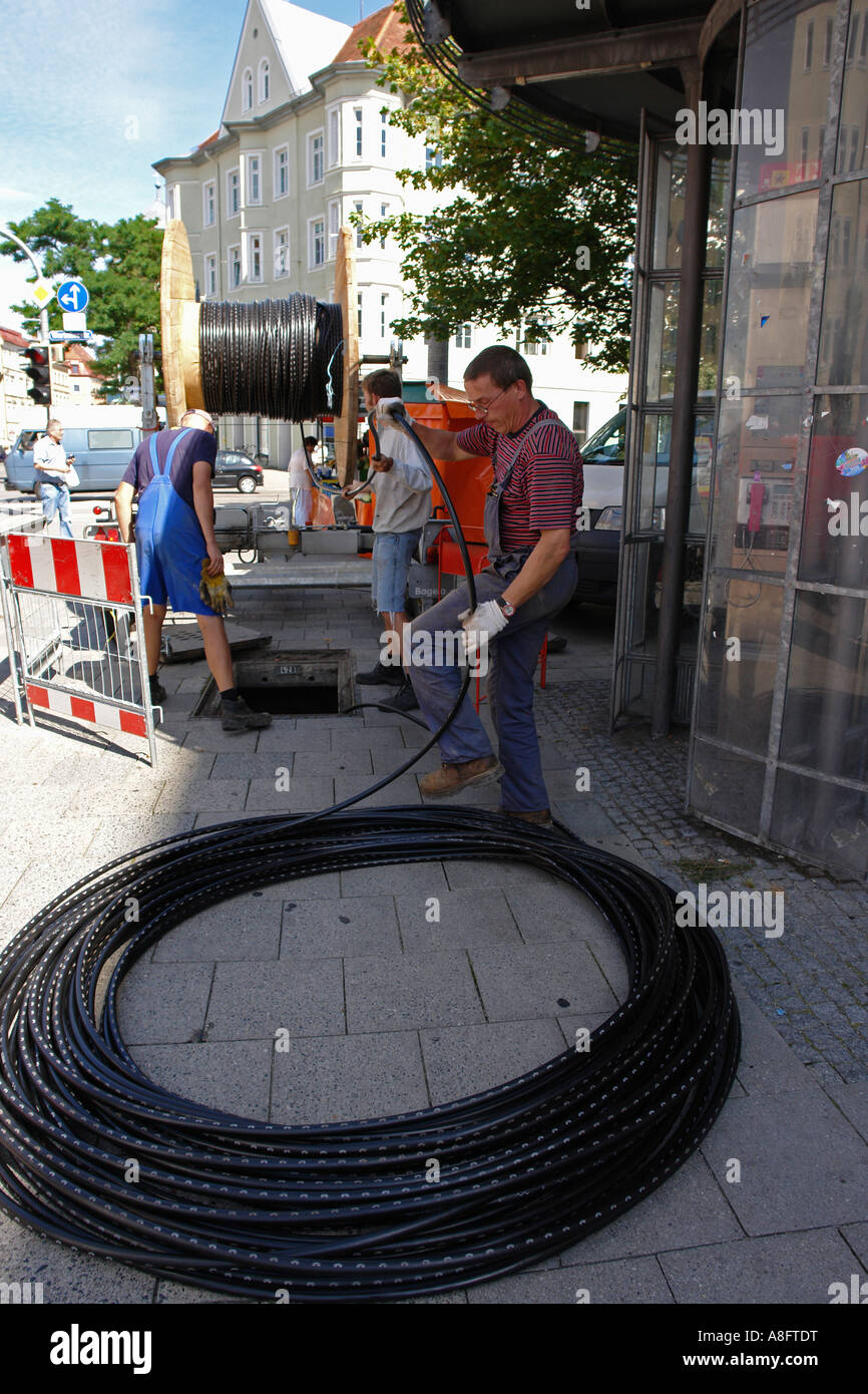 Worker lay underground cable in city Munich Bavaria Germany Stock Photo ...