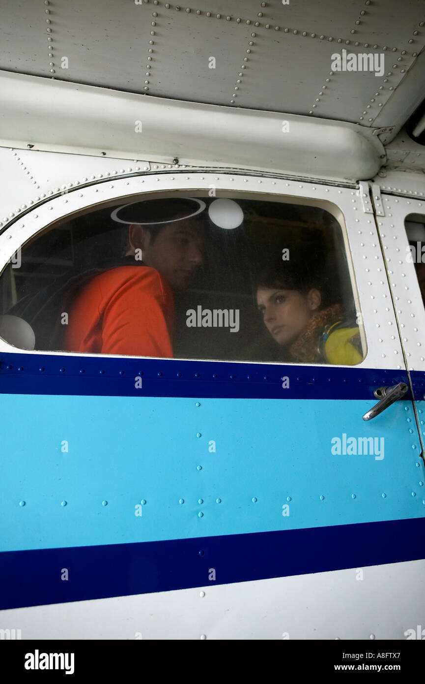 Couple wearing parachute gear, waiting inside a plane Stock Photo - Alamy