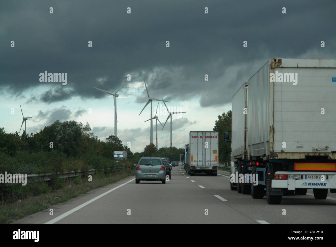 Wind turbines along the highway Stock Photo - Alamy