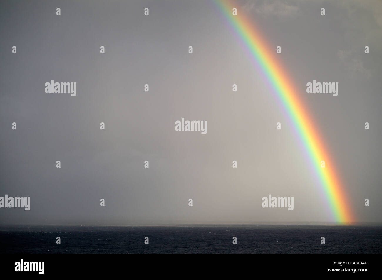 Rainbow over the sea Stock Photo - Alamy