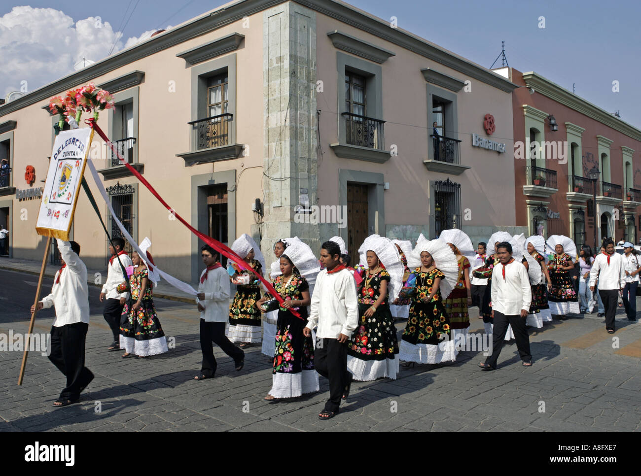 Students wearing traditional costumes take part in a parade in Oaxaca ...