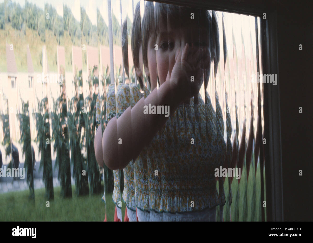 Child peers through the obscured glass in a door Stock Photo - Alamy