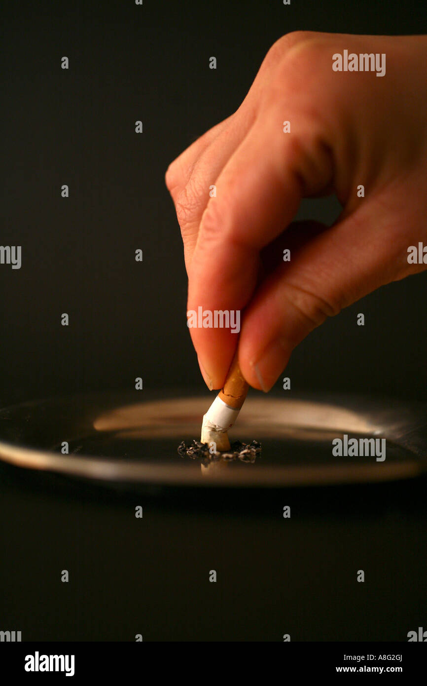 Stubbing out a cigarette Stock Photo - Alamy