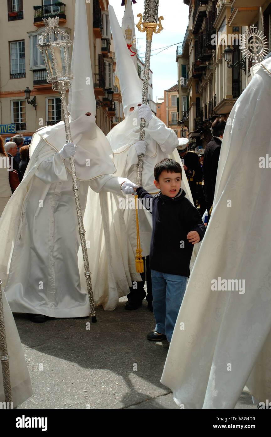 Young boy shakes hands with white hooded men in Easter Sunday ...