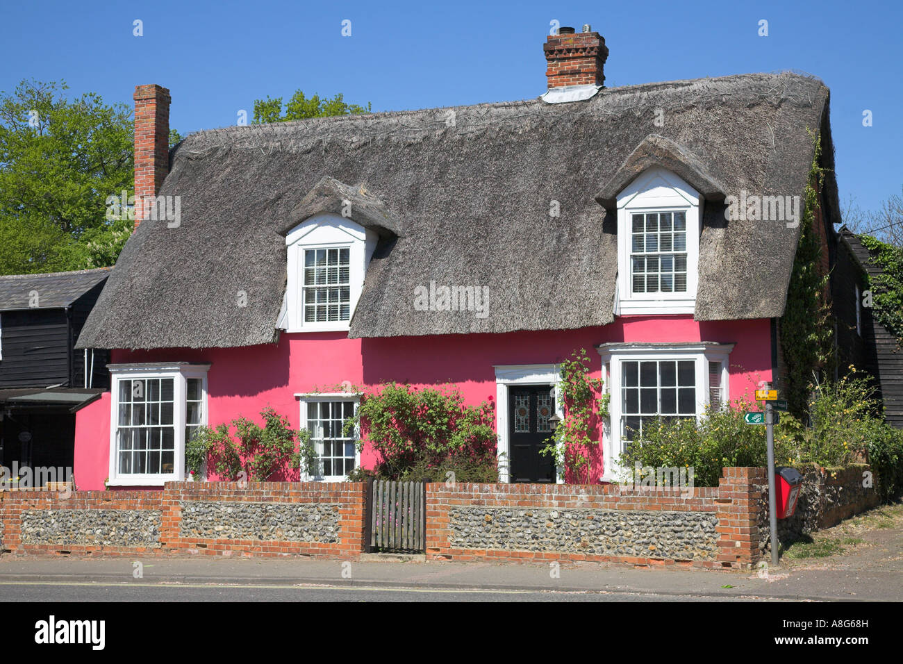 Pretty pink thatched cottage in the Suffolk village of Cavendish Stock ...
