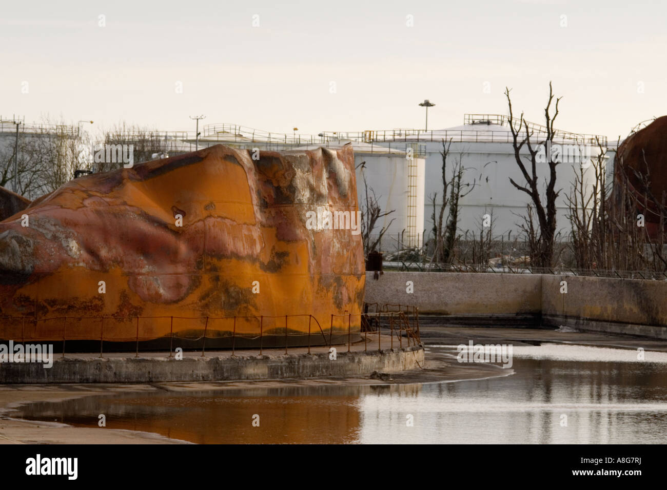 Damaged oil tank charred trees hi-res stock photography and images - Alamy