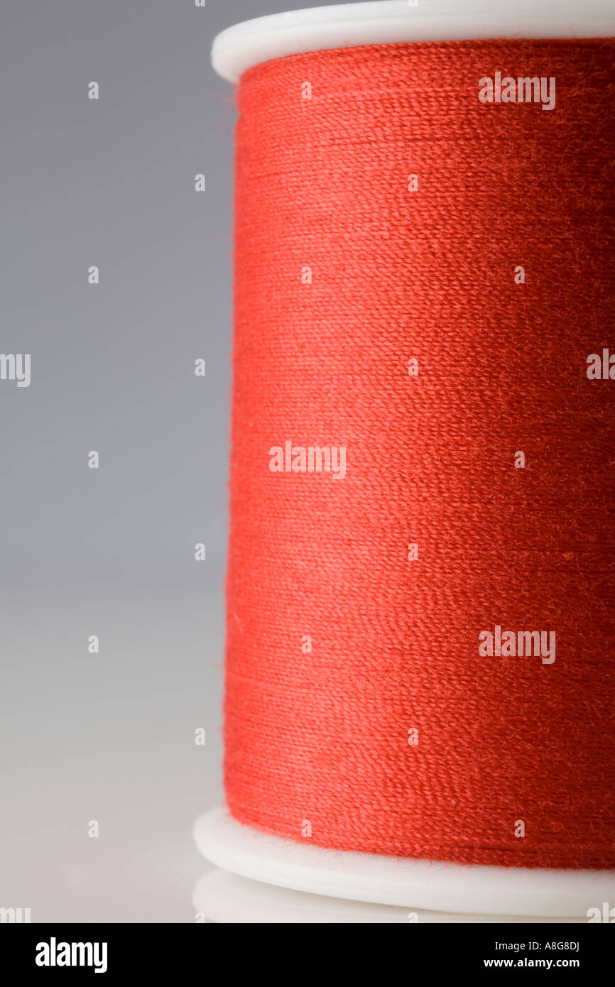 very close up to red cotton on its cotton reel Stock Photo - Alamy