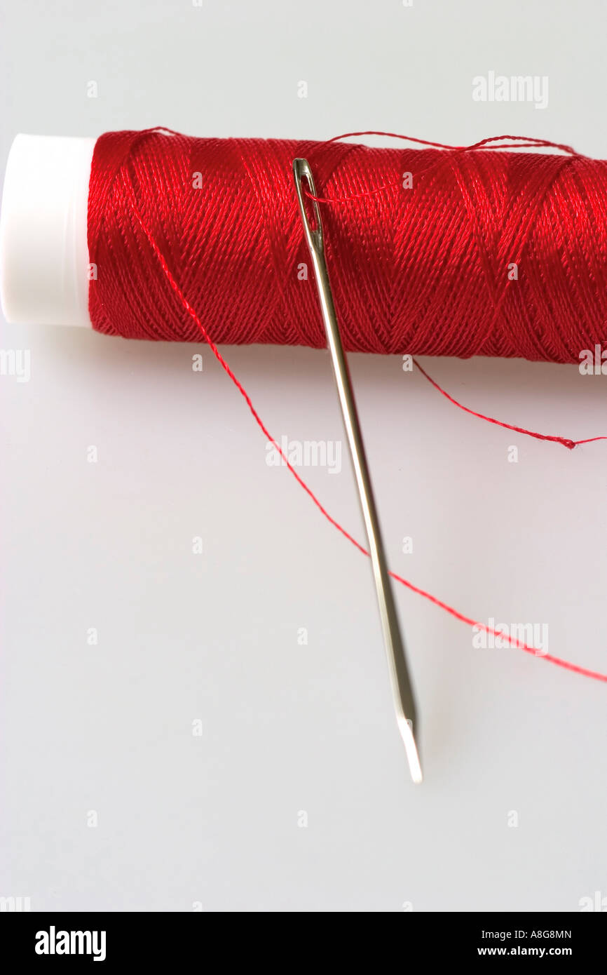 Steel needle with read thread Stock Photo - Alamy