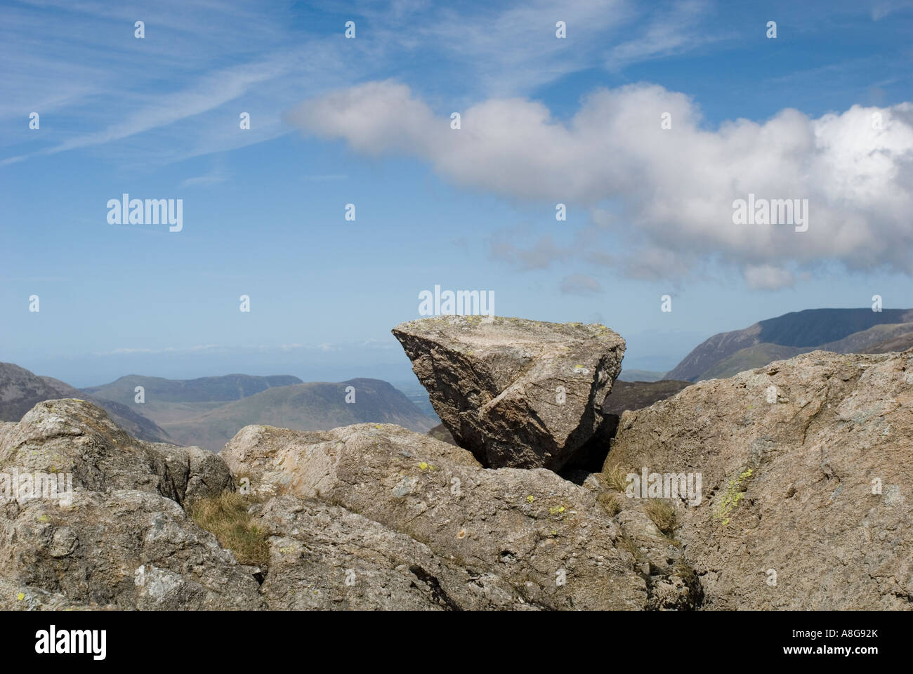 Stone balanced on wall in the Lake District Stock Photo - Alamy