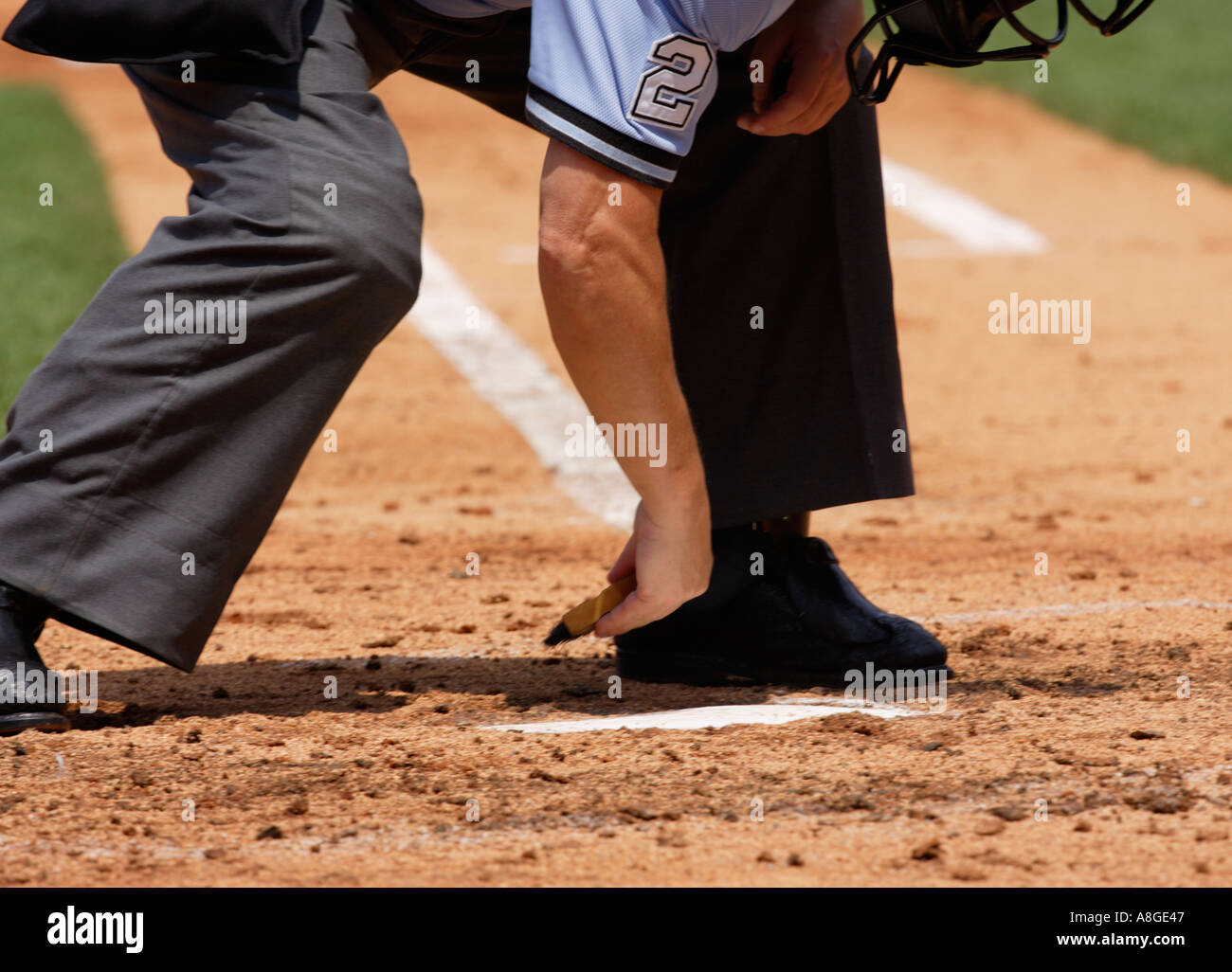 A baseball umpire cleaning home plate Stock Photo - Alamy