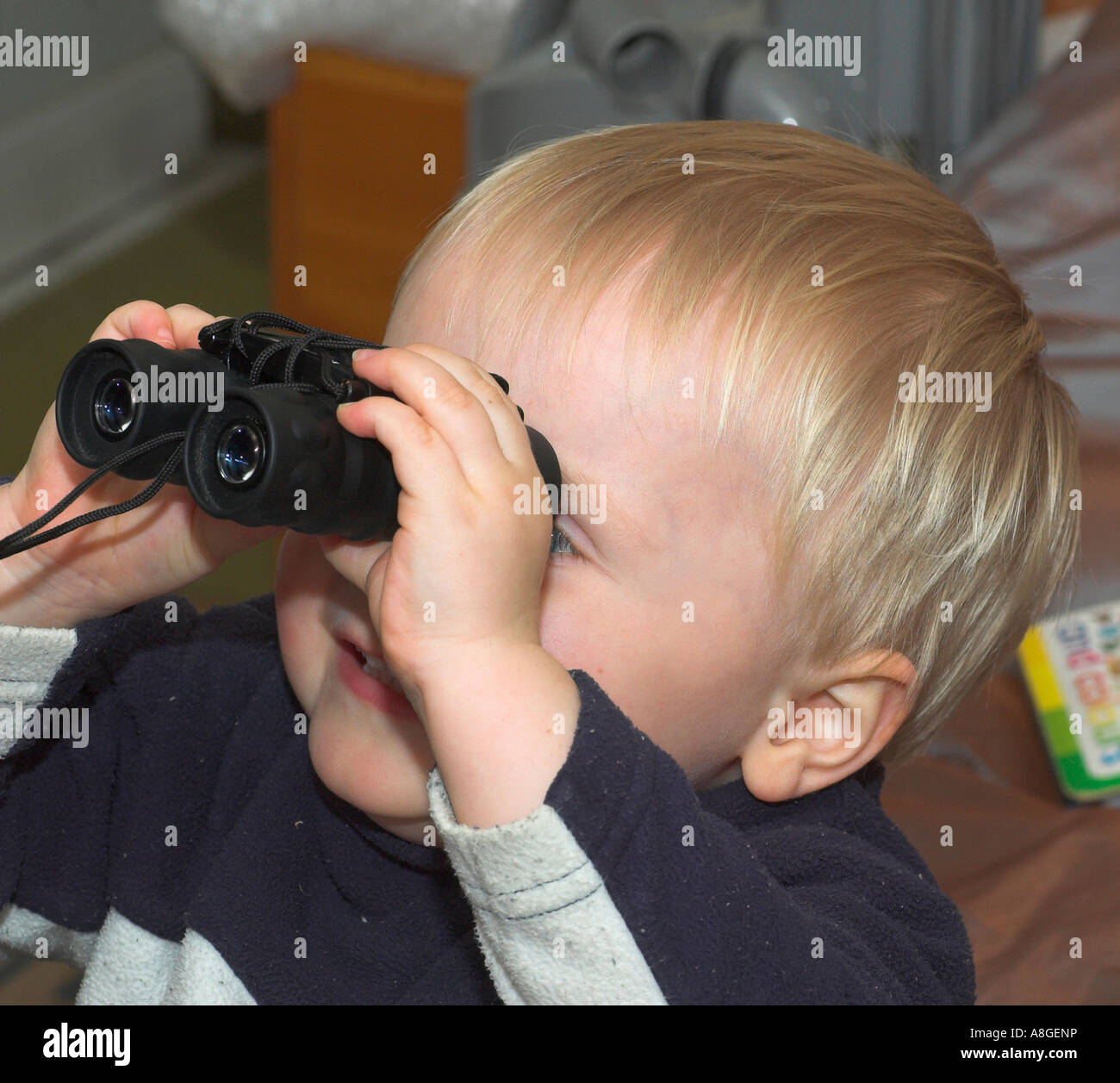 Boy looking through binoculars Stock Photo - Alamy