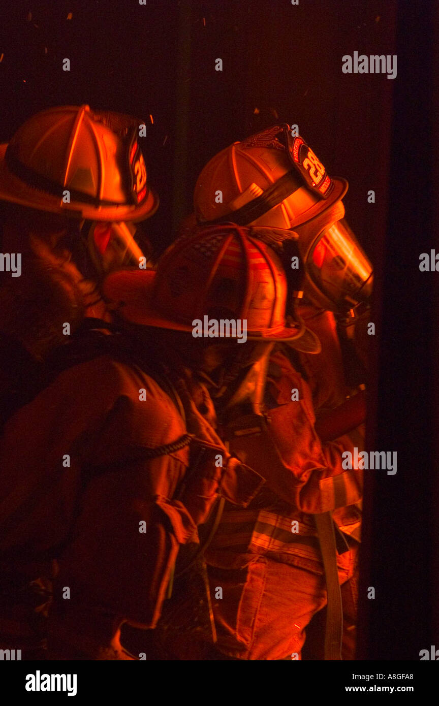 Firefighters inside burning building Stock Photo - Alamy