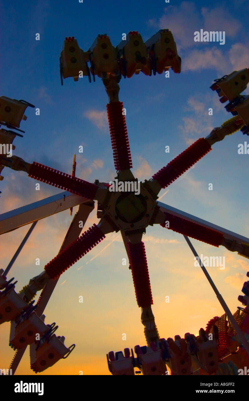 Carnival midway ride in motion at dusk Stock Photo - Alamy