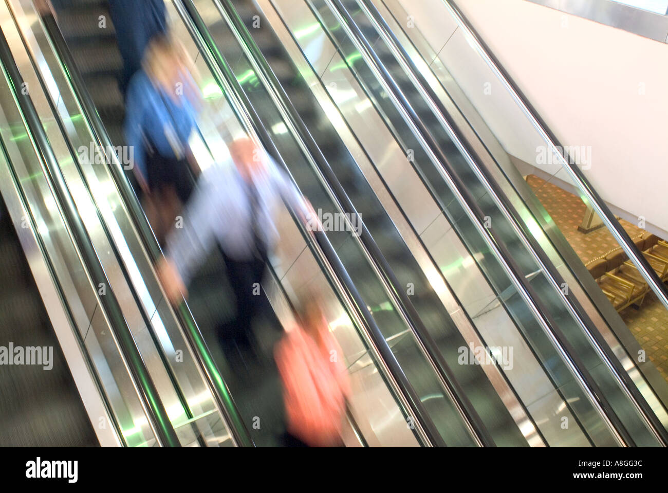 People riding escalator Stock Photo - Alamy
