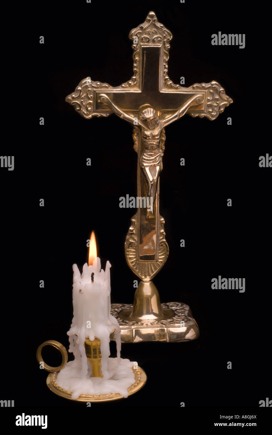 Christian cross with candle burning Stock Photo - Alamy