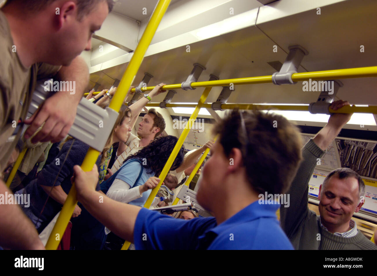 commuters on a crowded tube train Stock Photo - Alamy
